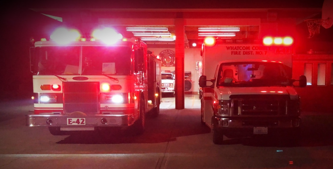 Whatcom Fire District 7 apparatus flash their red beacons at a fire ...